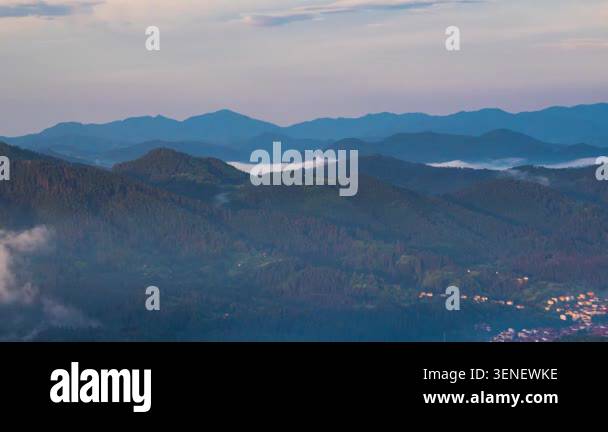 Green spring mountain valley sheltered by vegetation and spruce dark ...