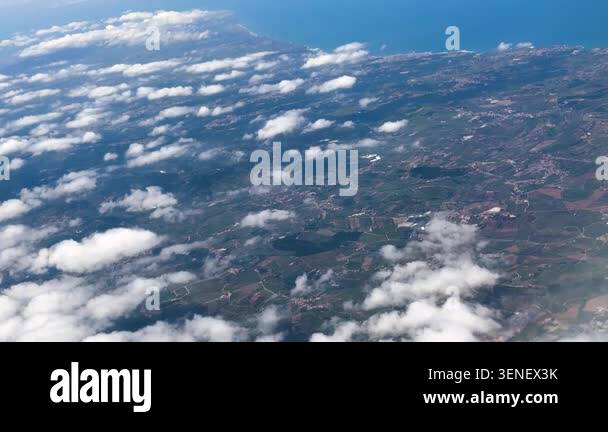 Scattered clouds drift above a vast countryside landscape viewed from ...