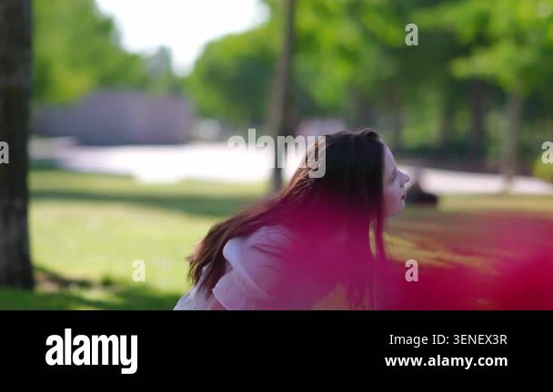 Side profile view of a contemplative young woman breathing fresh air at ...