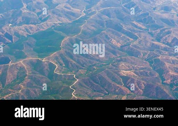Aerial view of winding roads across rugged hills. High quality 4k ...