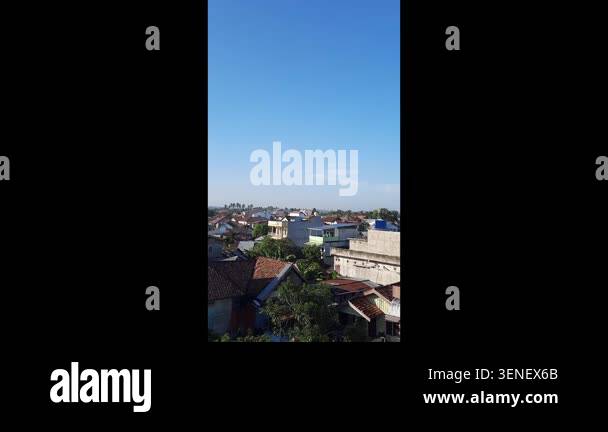 A wide vertical shot overlooking a dense residential neighborhood in a ...