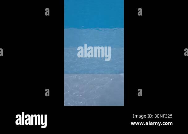 A top-down view of rippling bright blue water surface in a swimming ...