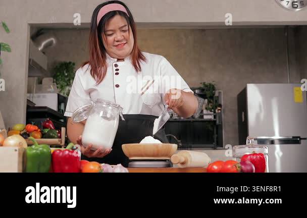 Fat woman chef making homemade italian pizza is scooping dough for ...