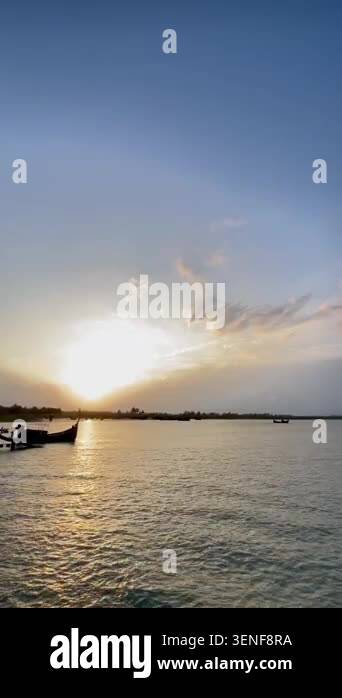 Scenic Sunset View of a Traditional Boat Moored Near Bridge, Gentle Sea ...