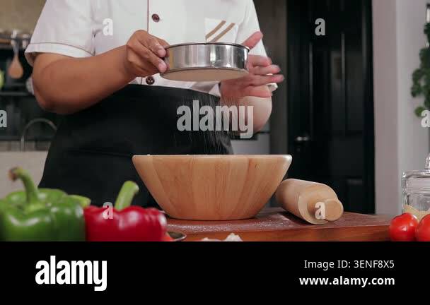 Fat woman chef making homemade Italian pizza is sifting flour through a ...