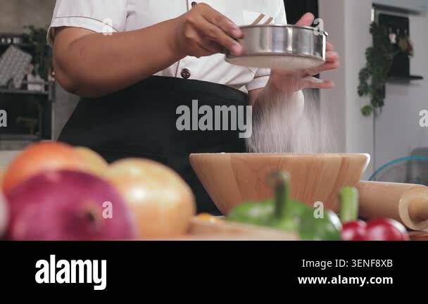 Fat woman chef making homemade Italian pizza is sifting flour through a ...