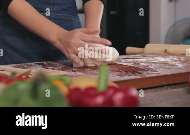 Professional female chef making homemade Italian pizza at home. Use ...