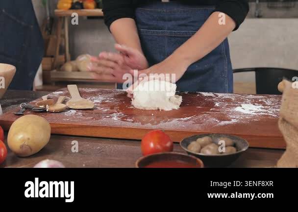 Female chef making homemade Italian pizza at home Use your hands to ...