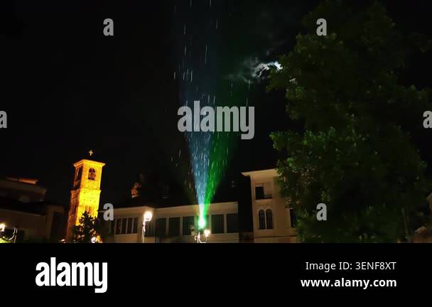 Bright light beam revealing falling raindrops beside historic Italian ...