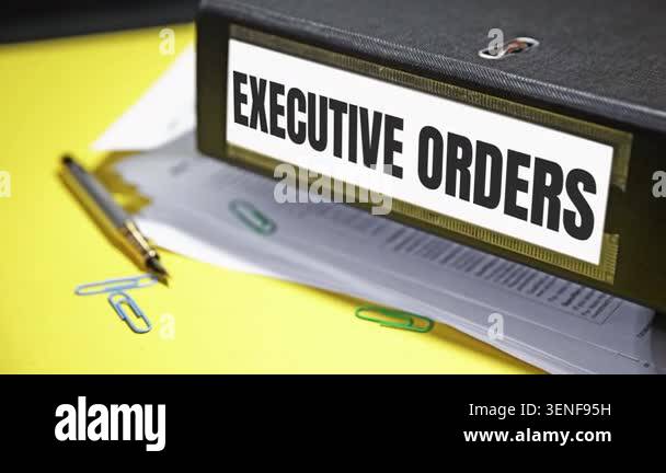 Black binder marked executive orders on desk with papers and pen, 4k ...