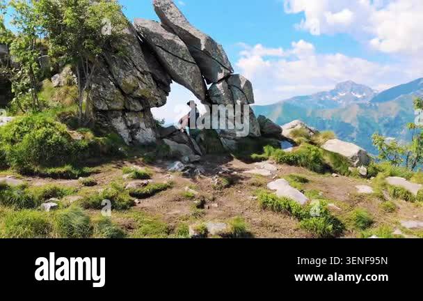 Tourist resting in natural rocky shelter formed by uniquely shaped ...