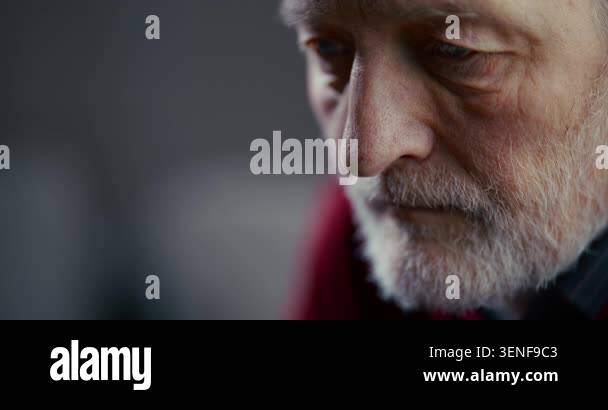 Close side view of an older man with gray hair and a white beard ...