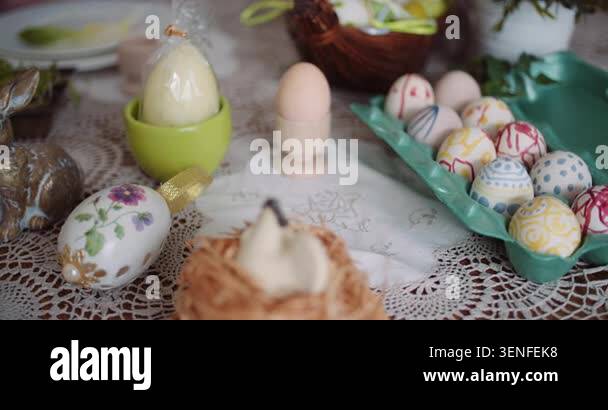 Colorful painted eggs arranged on a delicate lace tablecloth with a ...