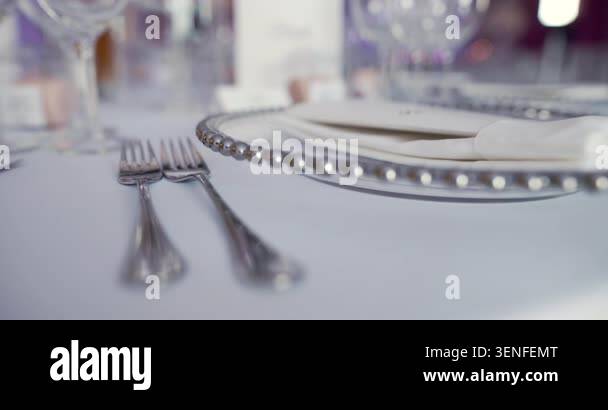 Close-up of a refined dining table arrangement with a beaded silver ...