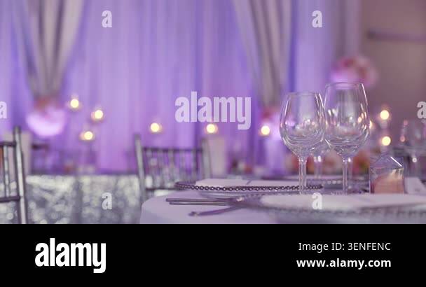 Empty formal dining table set with wine glasses, plates, and cutlery ...