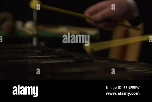 Close-up of a hand using a yellow-handled tool over an electronic ...