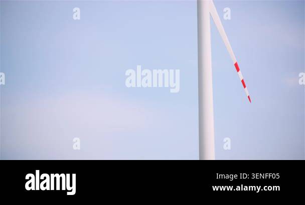 Minimal renewable energy scene with a white wind turbine on the right ...