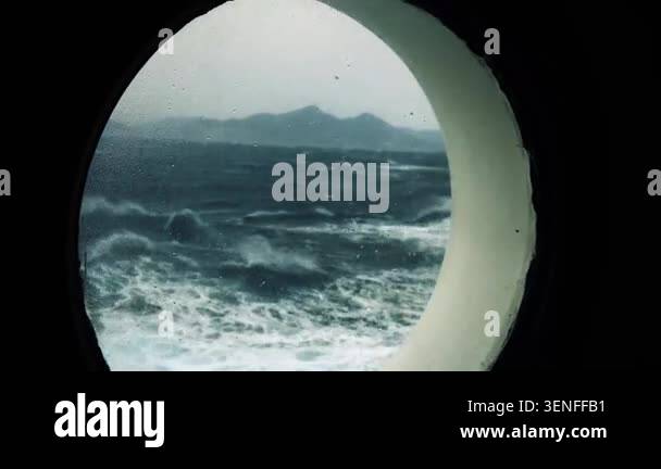A ship in a storm at sea, high waves shake the ship, the view from the ...
