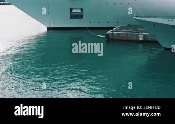 The ship is moored in the port, the ropes are lifted on board the ship ...