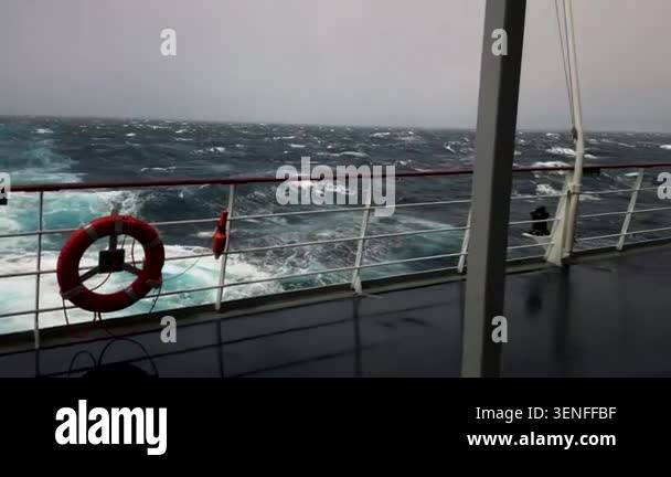 A ship in a storm at sea, high waves shake the ship, a view from the ...
