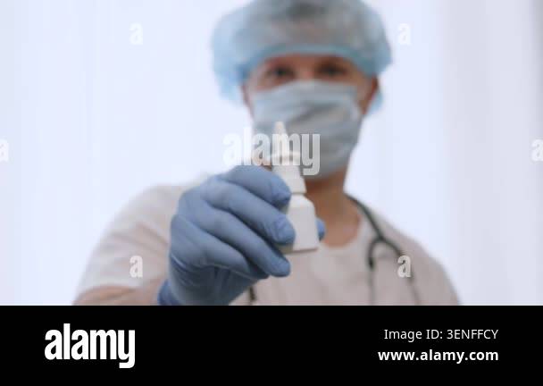 Male doctor with nasal spray for nose. Pediatrician in the clinic ...