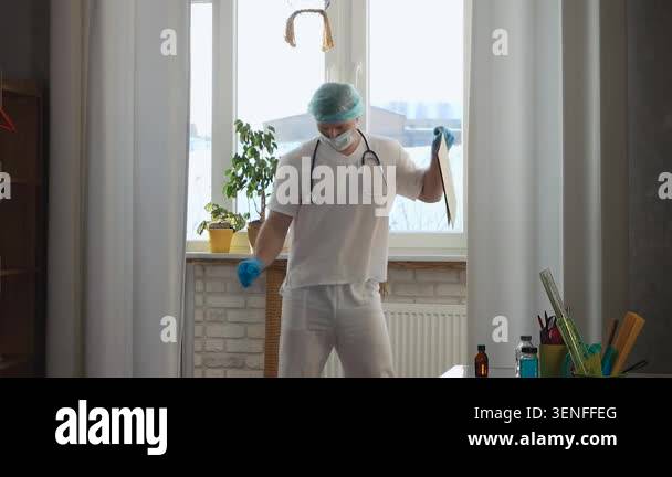 Cheerful doctor dancing listening to music, doctor in the clinic ...
