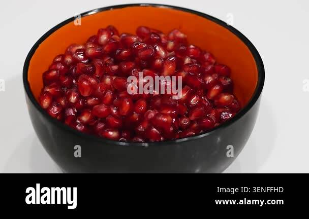 Peeled pomegranate fruit, ripe pomegranate in a plate, red berries ...