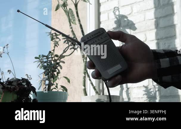 By hand tuning the radio waves on the radio, listen to the news on the ...
