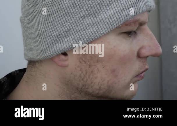 Bluetooth musical earphone in a guy's ear. A young man puts on an ...