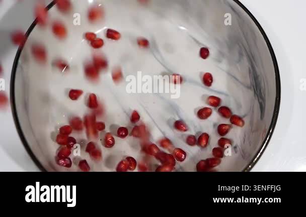 Top view, Fresh peeled pomegranate fruit poured into a plate, ripe ...