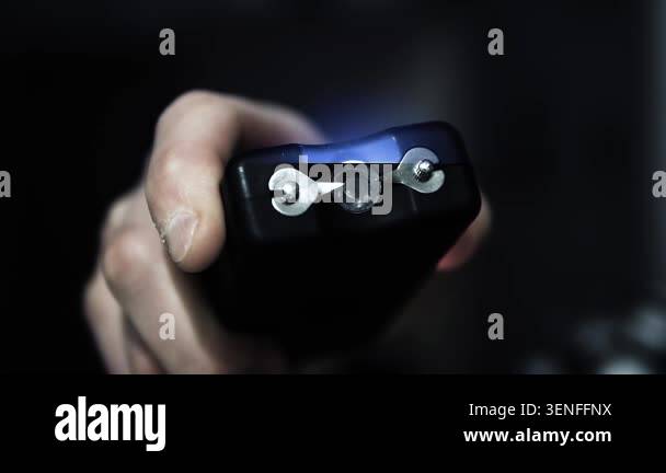 Stun gun in a man's hand, electric discharge, portable shocker, dog ...