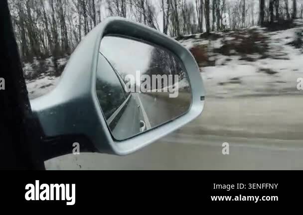 Driving a Car on a Highway Through Autumn Forest, View in the Rearview ...