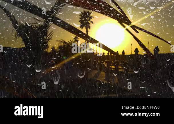 Animation Rain at sunset, thunderstorm on the seashore near the beach ...