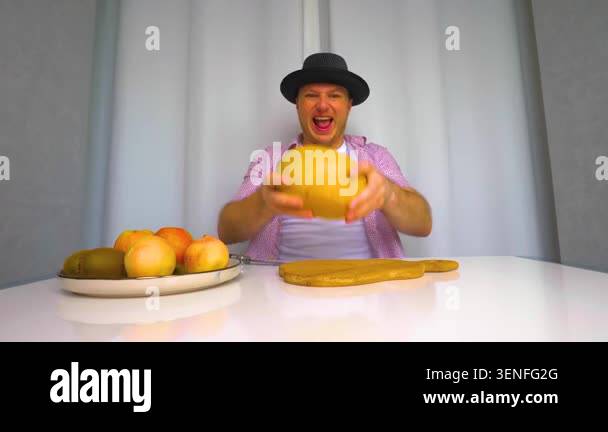 Man Throwing a melon up. Positive man with a melon in his hands Stock ...