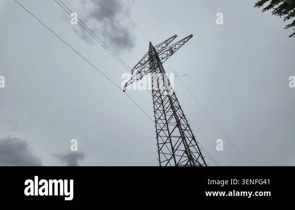 Low angle view of a high voltage transmission tower with power lines ...