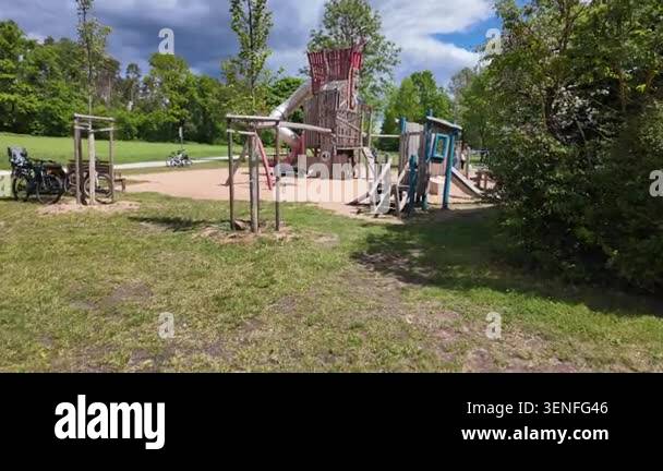 Outdoor shot of a spacious children playground with a large wooden ...