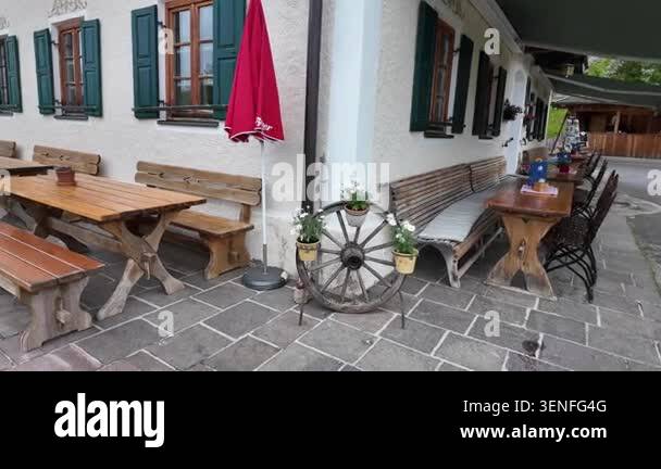 The frame showcases an outdoor dining area arranged along the white ...