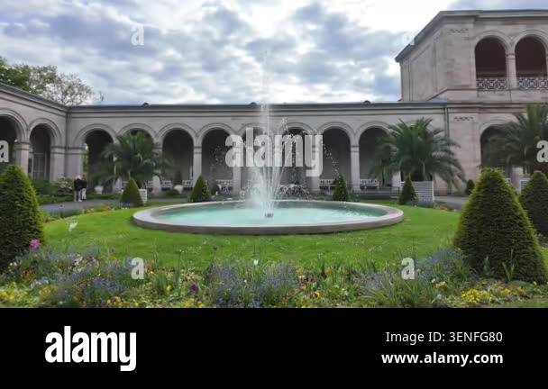 A spectacular view of an active circular water fountain splashing high ...