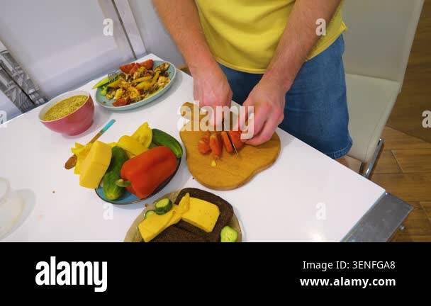 Cooking homemade food in the kitchen from vegetables, a man makes a ...