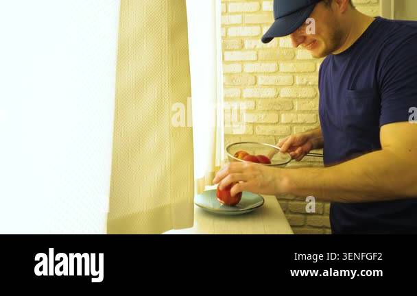 Peach in a plate, a man puts fruit nectarine in a plate. Slow motion ...