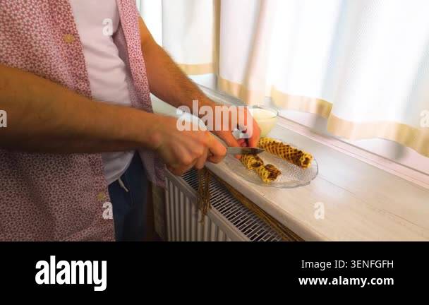Cut a waffle roll with condensed milk. Dessert in a plate with ...