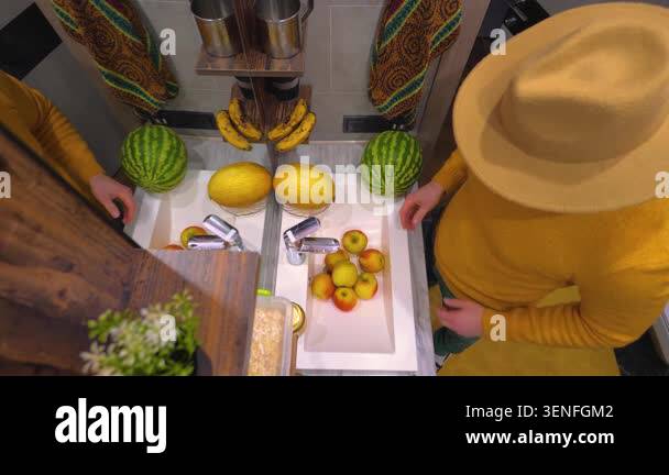 Wash apples under the water tap, top view. Male hands wash melon and ...