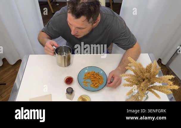 A man drinks water and cups while sitting at the table. Dine with fast ...