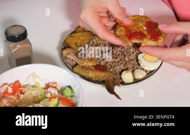 A man eats meat in red sauce with his hands. Appetizing man's dinner in ...