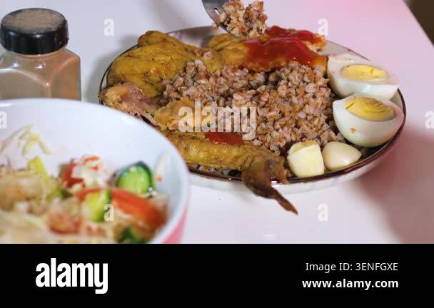 Appetizing buckwheat porridge in a plate with meat, garlic and hard ...