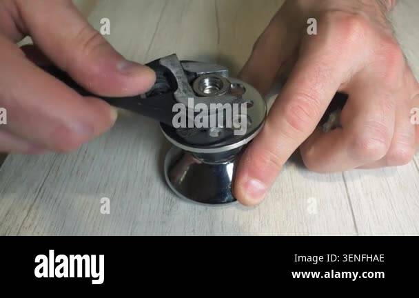 Tightening a nut with a wrench. A worker tightens a nut with a gas ...