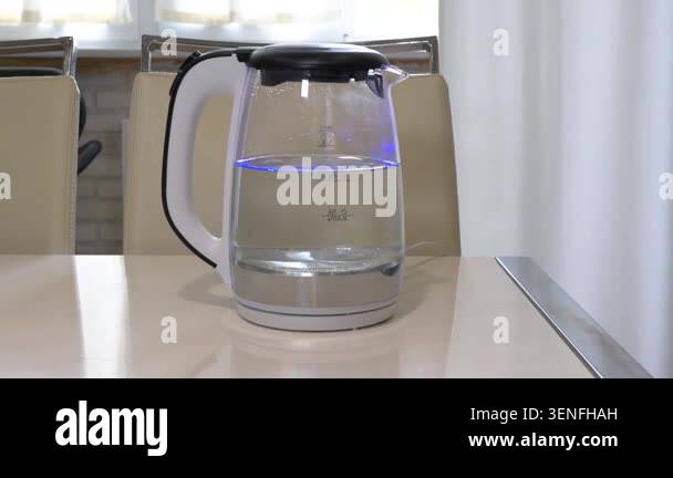Heating water in a transparent electric kettle. Boiling water in an ...