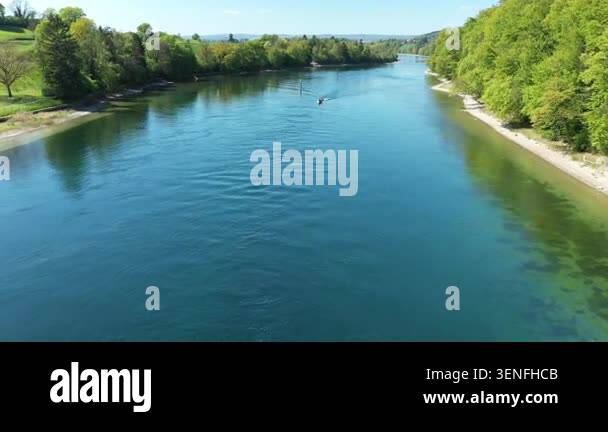 Drone flying towards motorboat on river and rising to reveal landscape ...