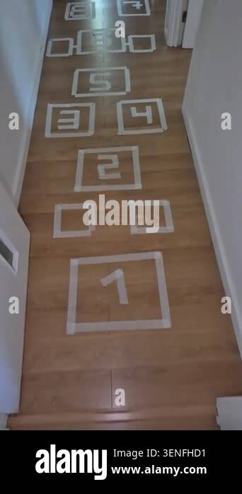 Hopscotch game marked in a home hallway, creating a playful indoor ...