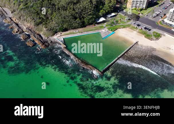 Aerial video panning around the ocean baths at Main Beach in Forster ...